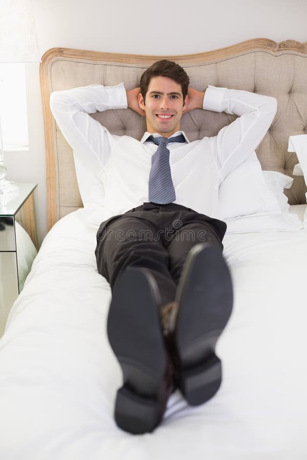 Relaxed Smiling Well Dressed Man Lying in Bed Stock Image - Image of ...