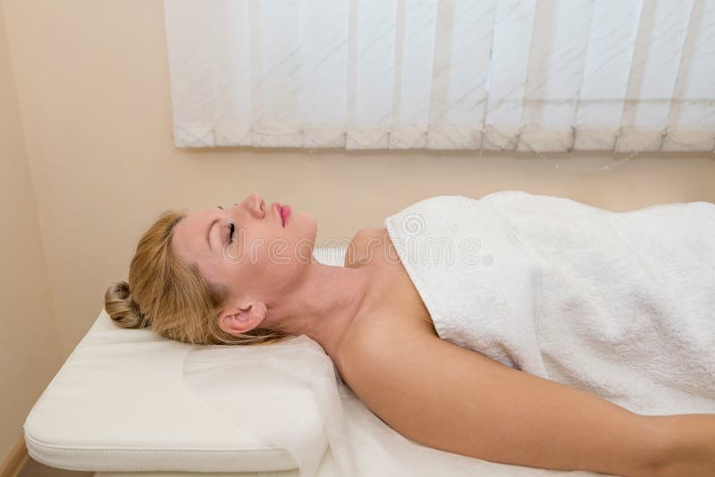 Woman Lying In Spa Salon With Closed Eyes Waiting For Massage Stock