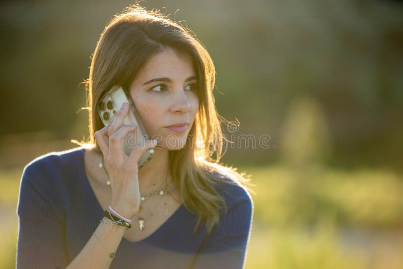 Relaxed Woman Talking on the Phone Outdoors Stock Image - Image of ...