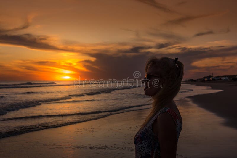 Relaxed Woman Watching the Sunset on the Beach. Summer and Vacation ...