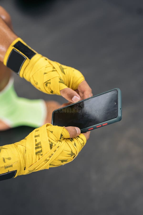 Relaxed Young Boxer Sitting on the Ring Using His Phone after Training ...