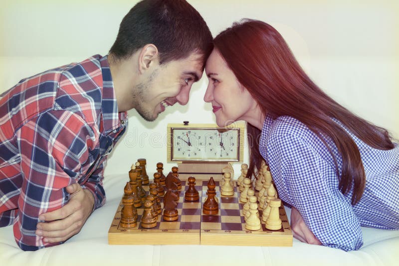 Relaxed Young Couple Playing Chess at Home Lying on Sofa. Won ...