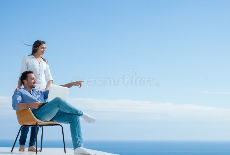 Relaxed Young Couple Working on Laptop Computer at Home Stock Image ...