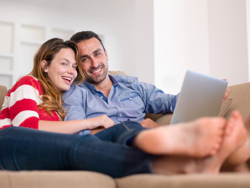 Relaxed Young Couple Working on Laptop Computer at Home Stock Photo ...
