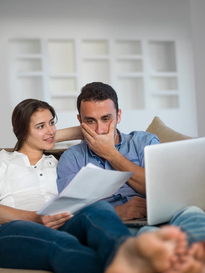 Relaxed Young Couple Working on Laptop Computer at Home Stock Photo ...