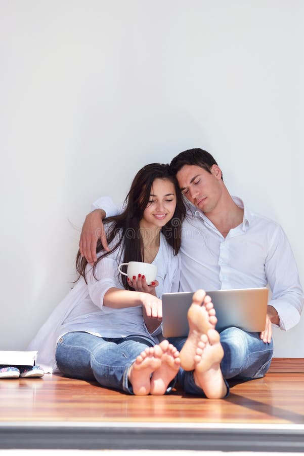 Relaxed Young Couple Working on Laptop Computer at Home Stock Image ...