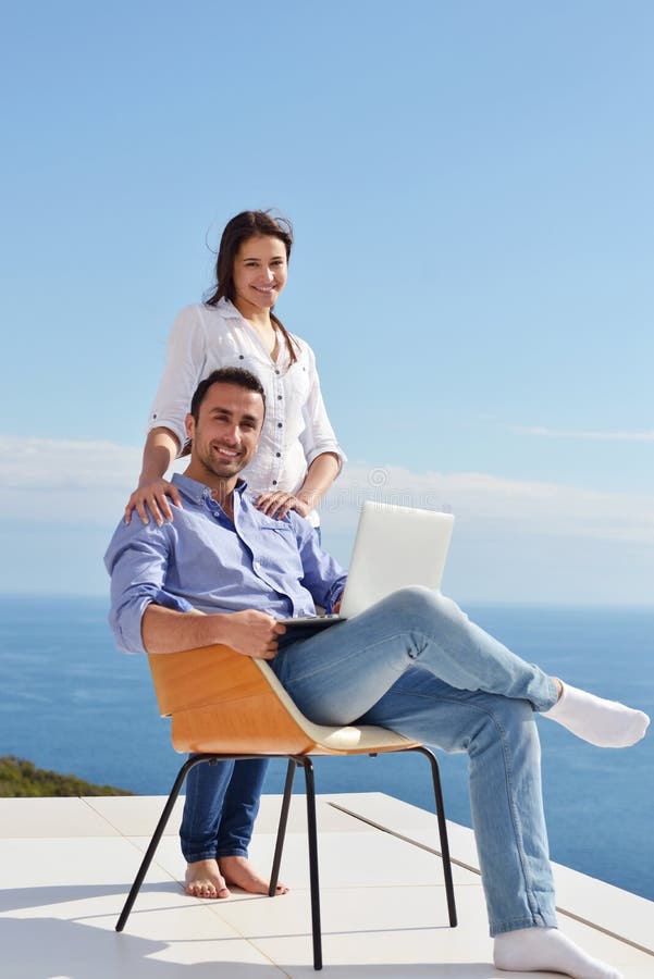 Relaxed Young Couple Working on Laptop Computer at Home Stock Photo ...