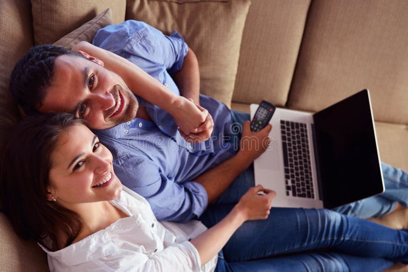 Relaxed Young Couple Working on Laptop Computer at Home Stock Photo ...