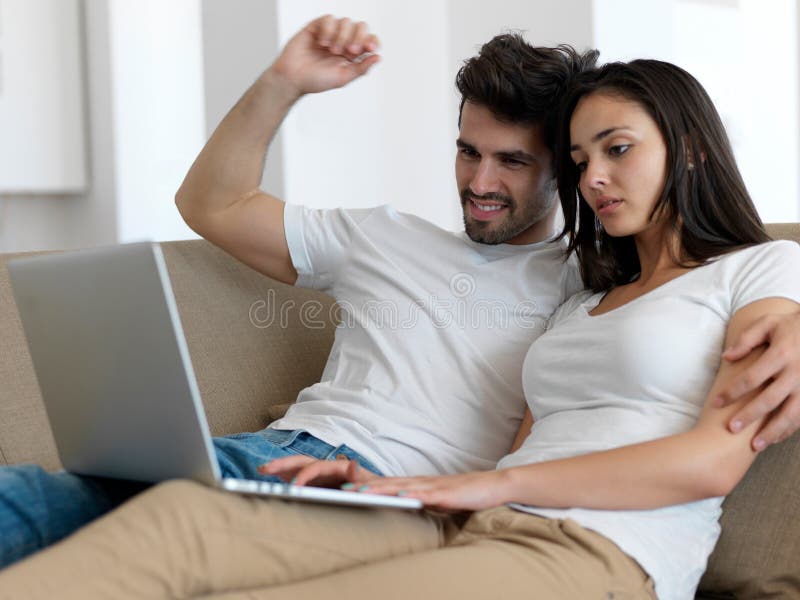 Relaxed Young Couple Working on Laptop Computer at Home Stock Image ...