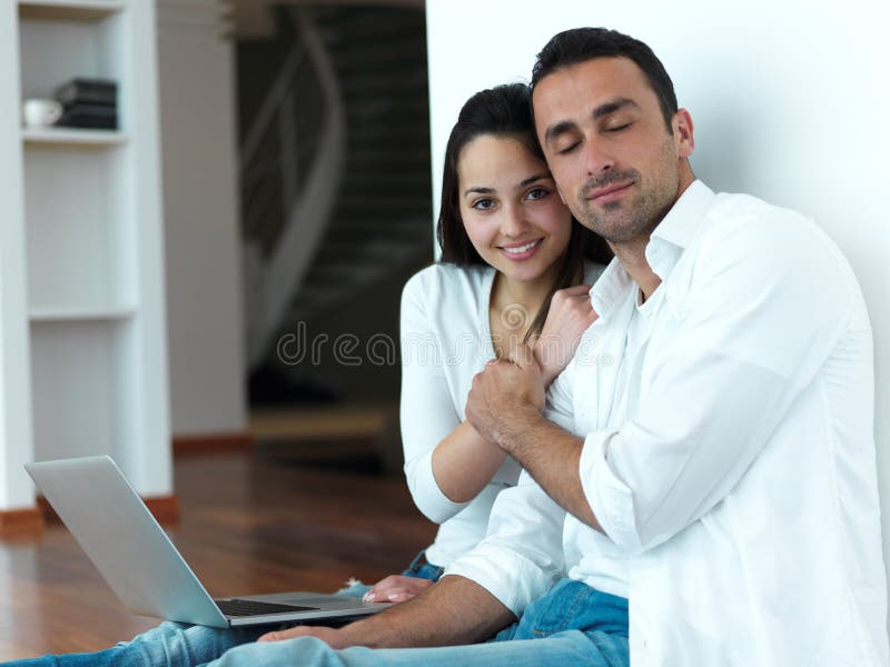 Relaxed Young Couple Working on Laptop Computer at Home Stock Image ...