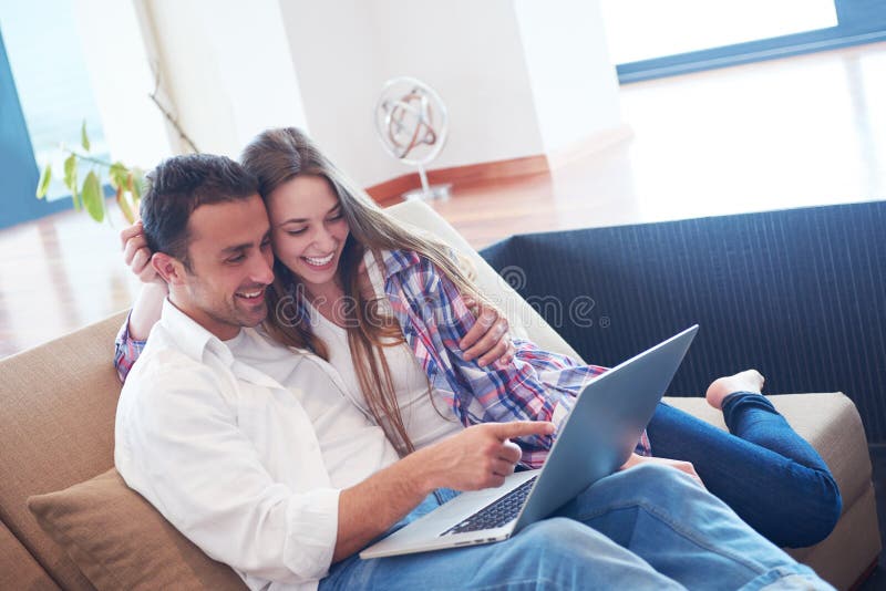 Relaxed Young Couple Working on Laptop Computer at Home Stock Photo ...