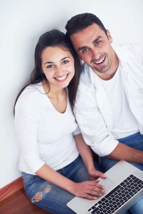 Relaxed Young Couple Working on Laptop Computer at Home Stock Photo ...