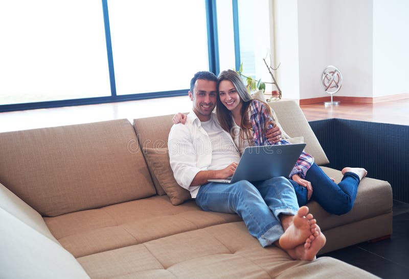 Relaxed Young Couple Working on Laptop Computer at Home Stock Photo ...