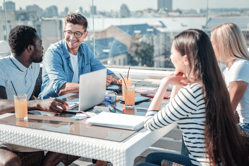 Relaxed Young People Smiling while Discussing Something Stock Photo ...
