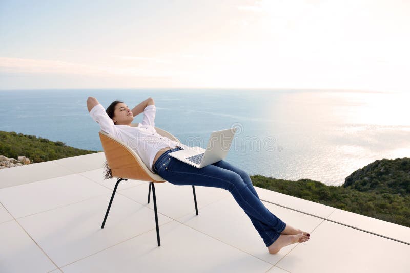 Relaxed Young Woman at Home Working on Laptop Stock Photo - Image of ...