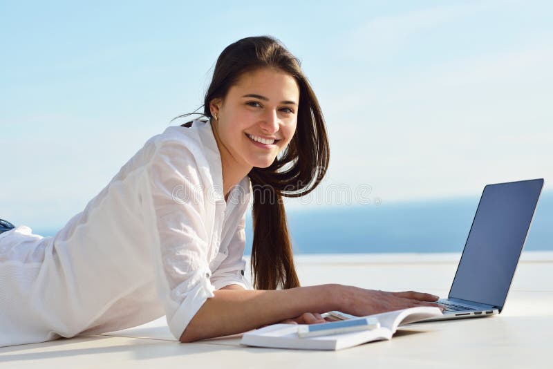 Relaxed Young Woman at Home Working on Laptop Computer Stock Photo ...