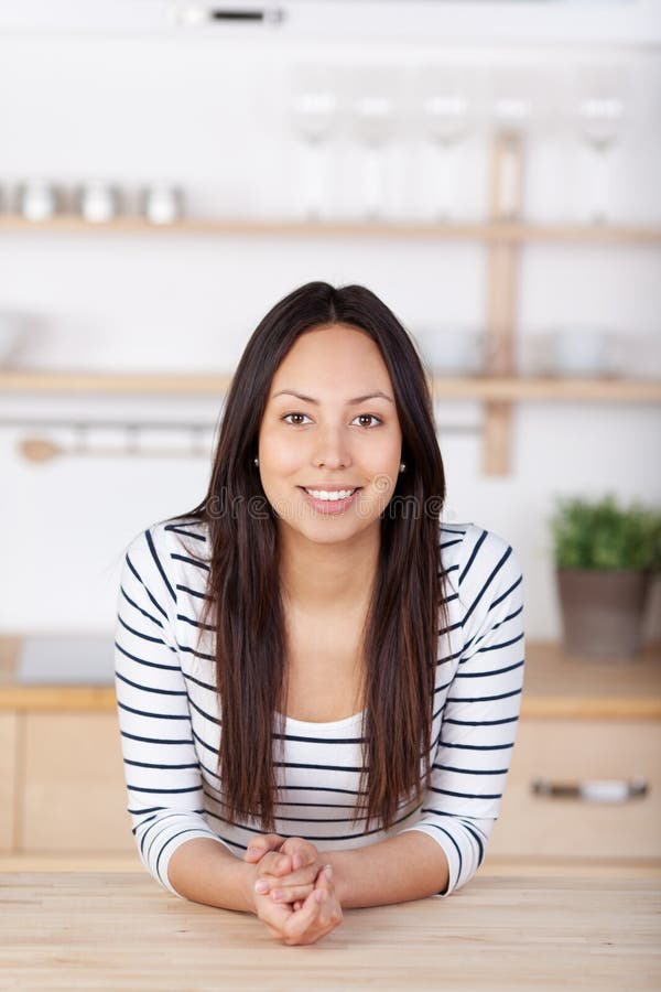 Relaxed Young Woman Leaning on the Kitchen Table Stock Photo - Image of ...