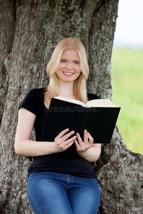Relaxed Young Woman Reading a Book Stock Photo - Image of girl, meadow ...