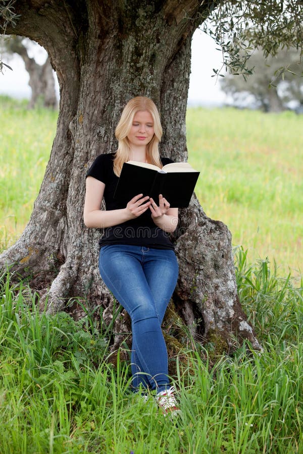 Relaxed Young Woman Reading a Book Stock Photo - Image of caucasian ...