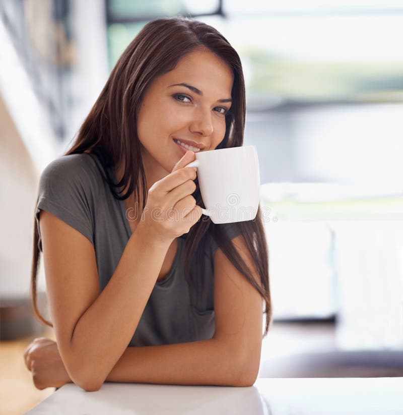 Relaxing with a Cup of Java. an Attractive Young Woman Drinking a ...