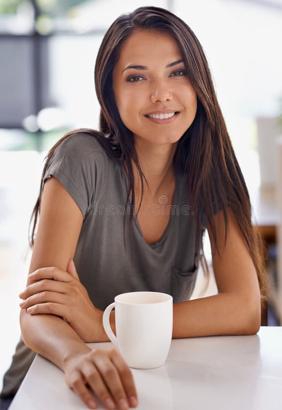 Relaxing with a Cup of Java. an Attractive Young Woman Drinking a Coffee at Home. Stock Image ...