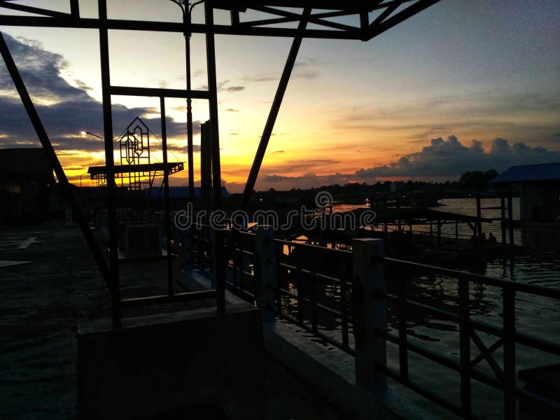 Relaxing on the Edge of the Pier while Enjoying the Sunset. Stock Photo ...