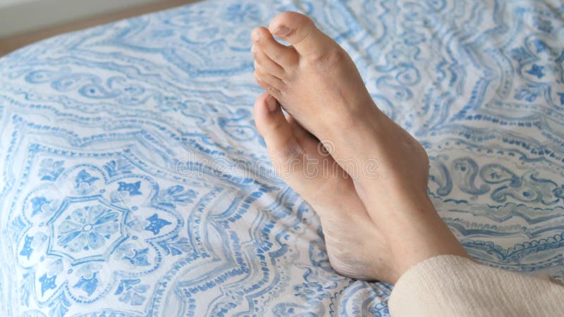 Relaxing Feet on Soft Bedding Creates a Calm Indoor Atmosphere Stock ...