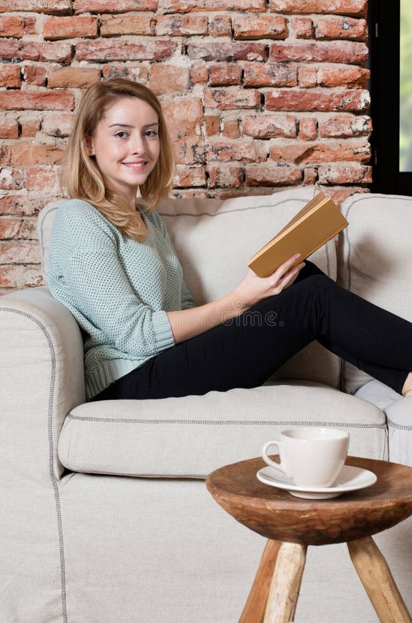 Relaxing with a good book stock image. Image of living - 128687933