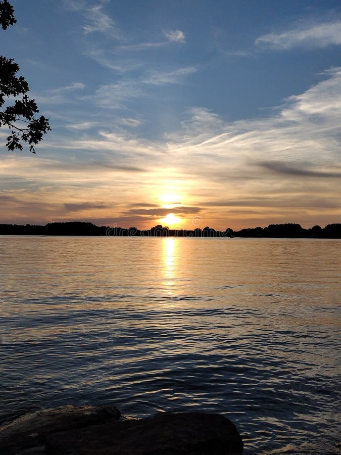 Relaxing by the Lake with a Sunset Stock Photo - Image of winter ...