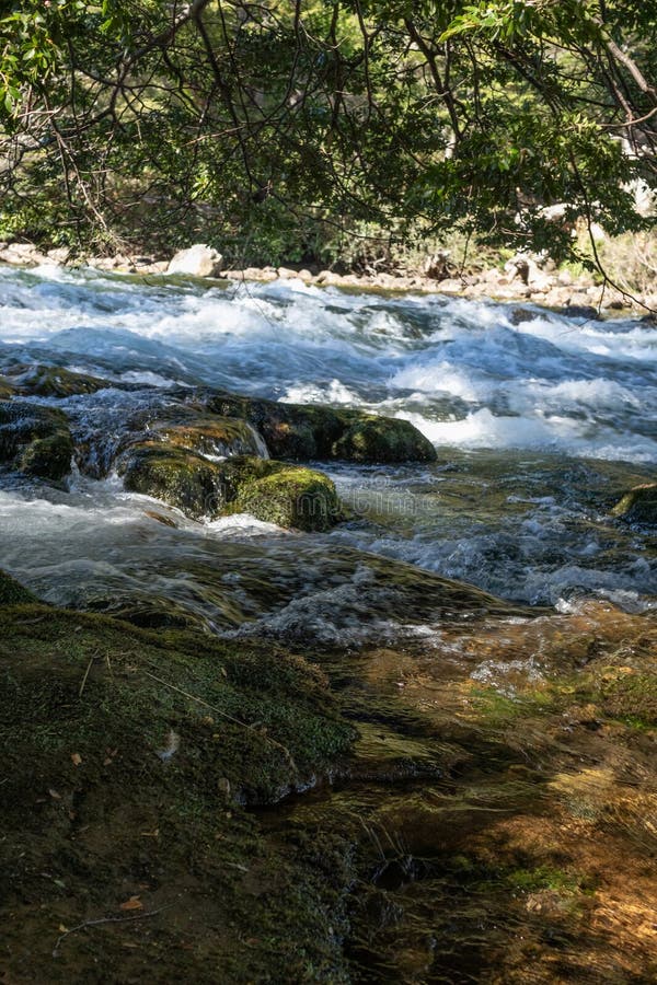 Relaxing Landscape of a River Flowing through Rocks in the Middle of a ...