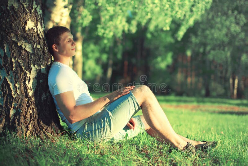 Relaxing Man is Dreaming Under a Tree with Eyes Closed Meditating ...