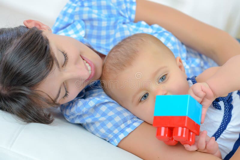Relaxing mum with baby stock image. Image of innocent - 217134921