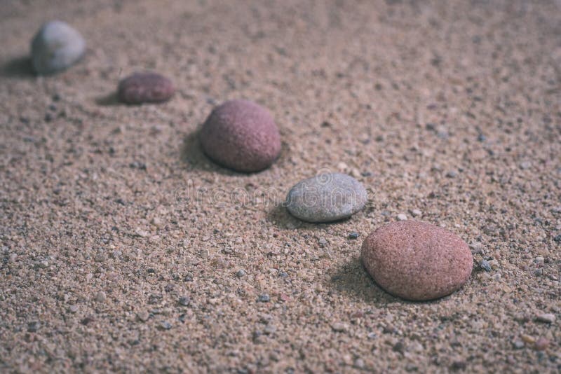 Relaxing Stones Laying on Sand Textured Pattern - Vintage Retro Look ...