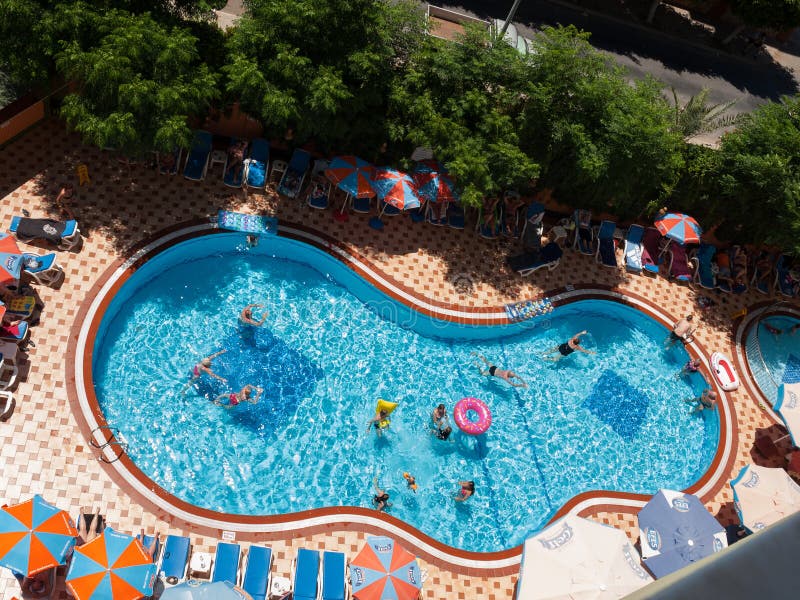 Relaxing on swimming-pool editorial photography. Image of male - 55185067