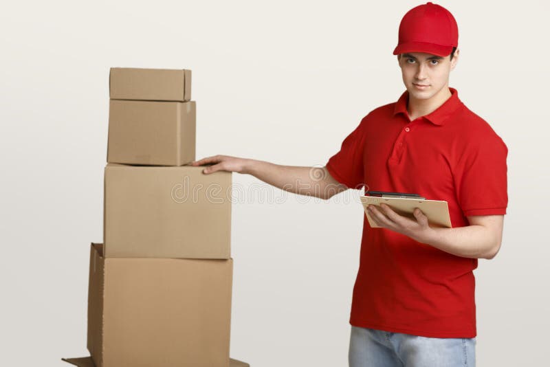 Reliable Delivery. Courier Checks Parcels in Warehouse with Tablet ...