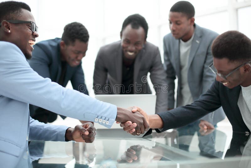 Reliable Handshake of Business Partners Over the Desktop. Stock Photo ...