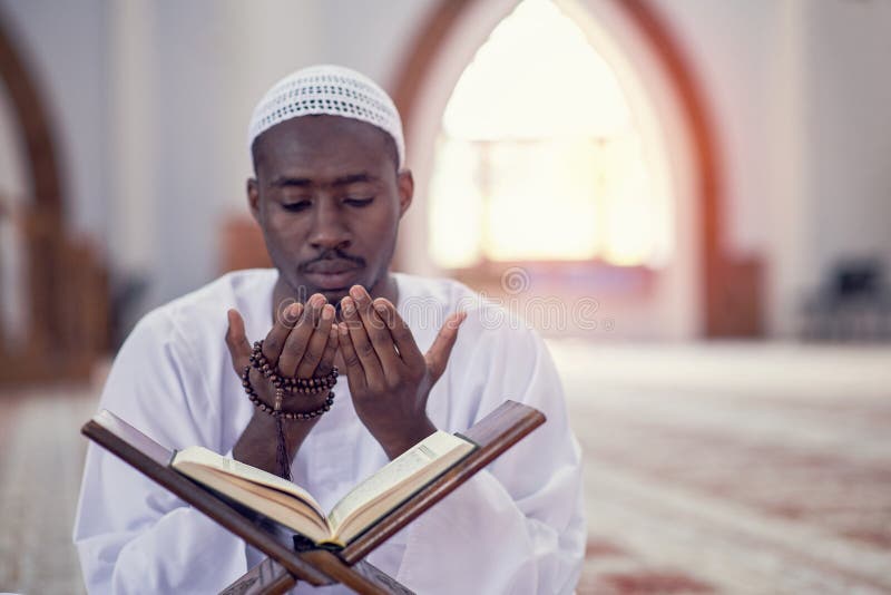 Black African Muslim Man is Praying in the Mosque with Open Holy Book ...