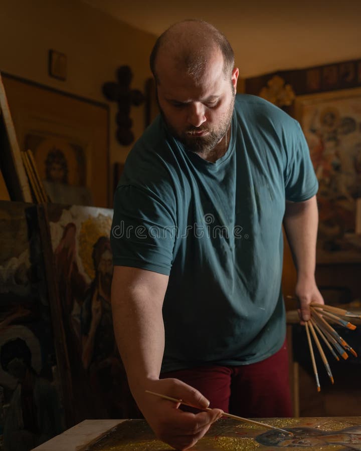 Religious Icon Painter Man Paints a New Icon with Brush at Workshop ...