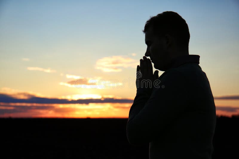 Religious Man Praying Outdoors at Sunset Stock Photo - Image of ...