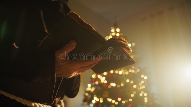 Religious Monk Prays on Christmas Night with Open Gospel in Front of ...