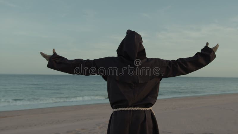 Religious Monk with Prays Towards the Sea with Open Arms Stock Video ...