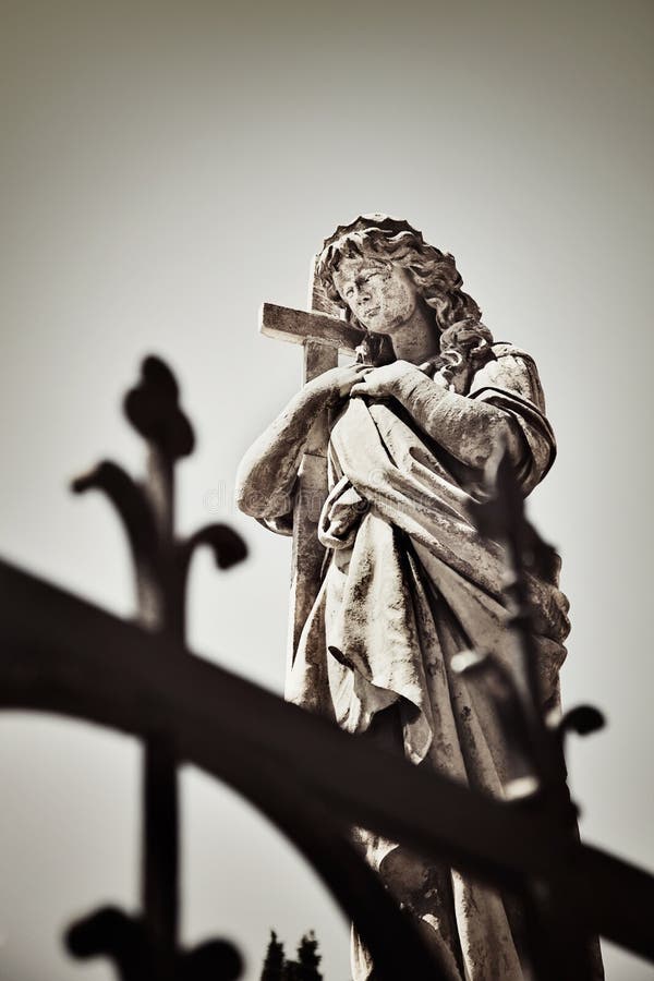 Religious statue on a rock stock image. Image of rock - 334716023