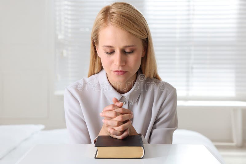 Religious Young Woman with Bible Praying at Home Stock Photo - Image of ...