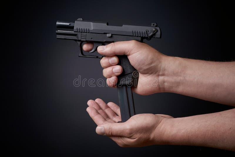 Loading the gun stock photo. Image of hand, load, firearm - 117077948
