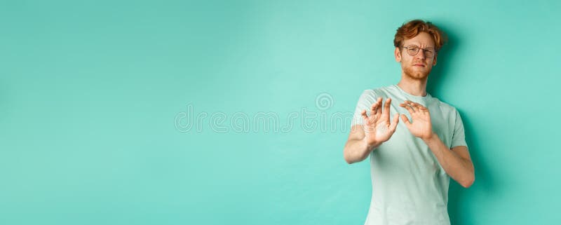 Reluctant Redhead Man In Glasses Raising Hands In Refusal Gesture Step