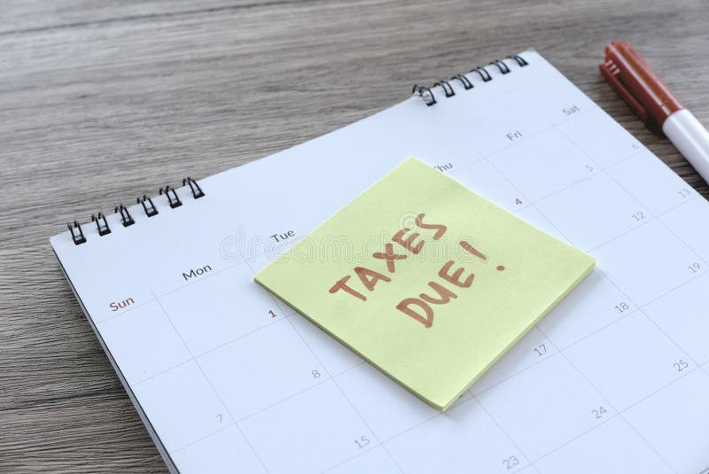 Reminder for Taxes Due on Calendar with Sticky Note and Red Marker ...