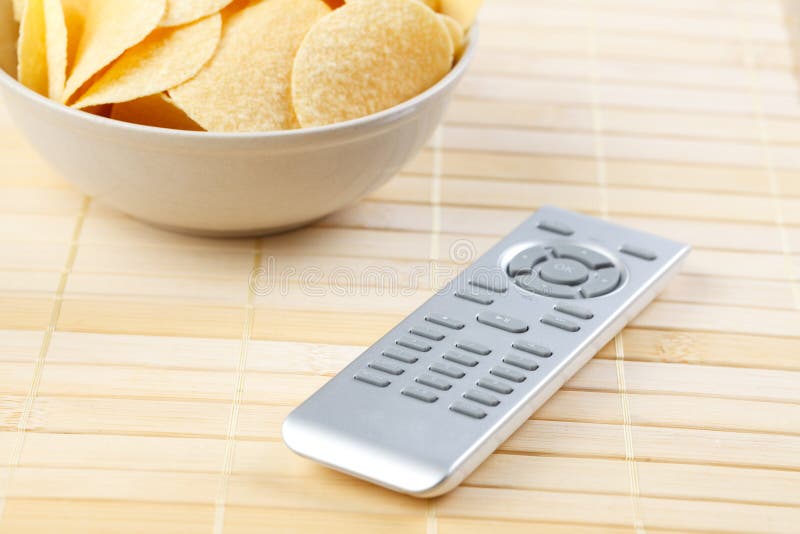 Remote control and chips stock photo. Image of movie - 13449380