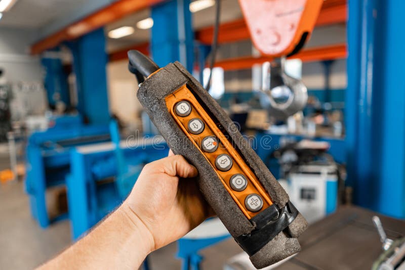 Remote Control of the Crane on Production. Workers Working with a Crane ...