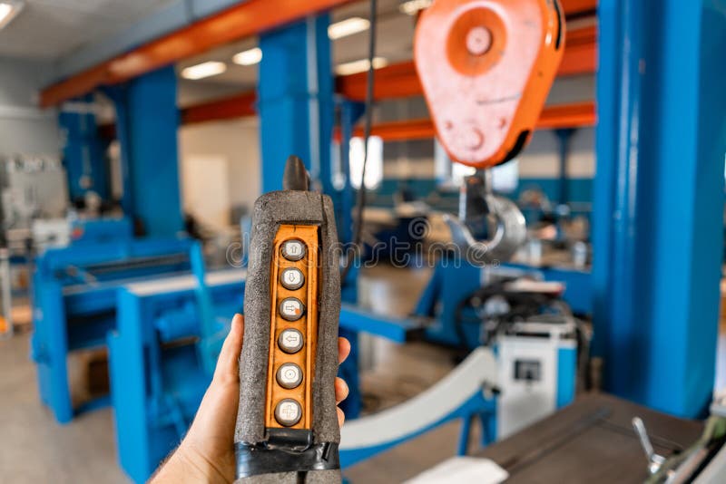 Remote Control of the Crane on Production. Workers Working with a Crane ...