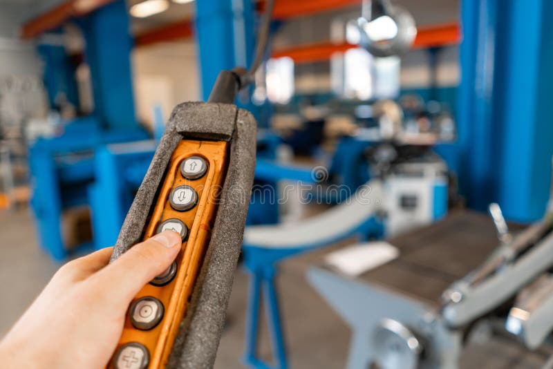 Remote Control of the Crane on Production. Workers Working with a Crane ...
